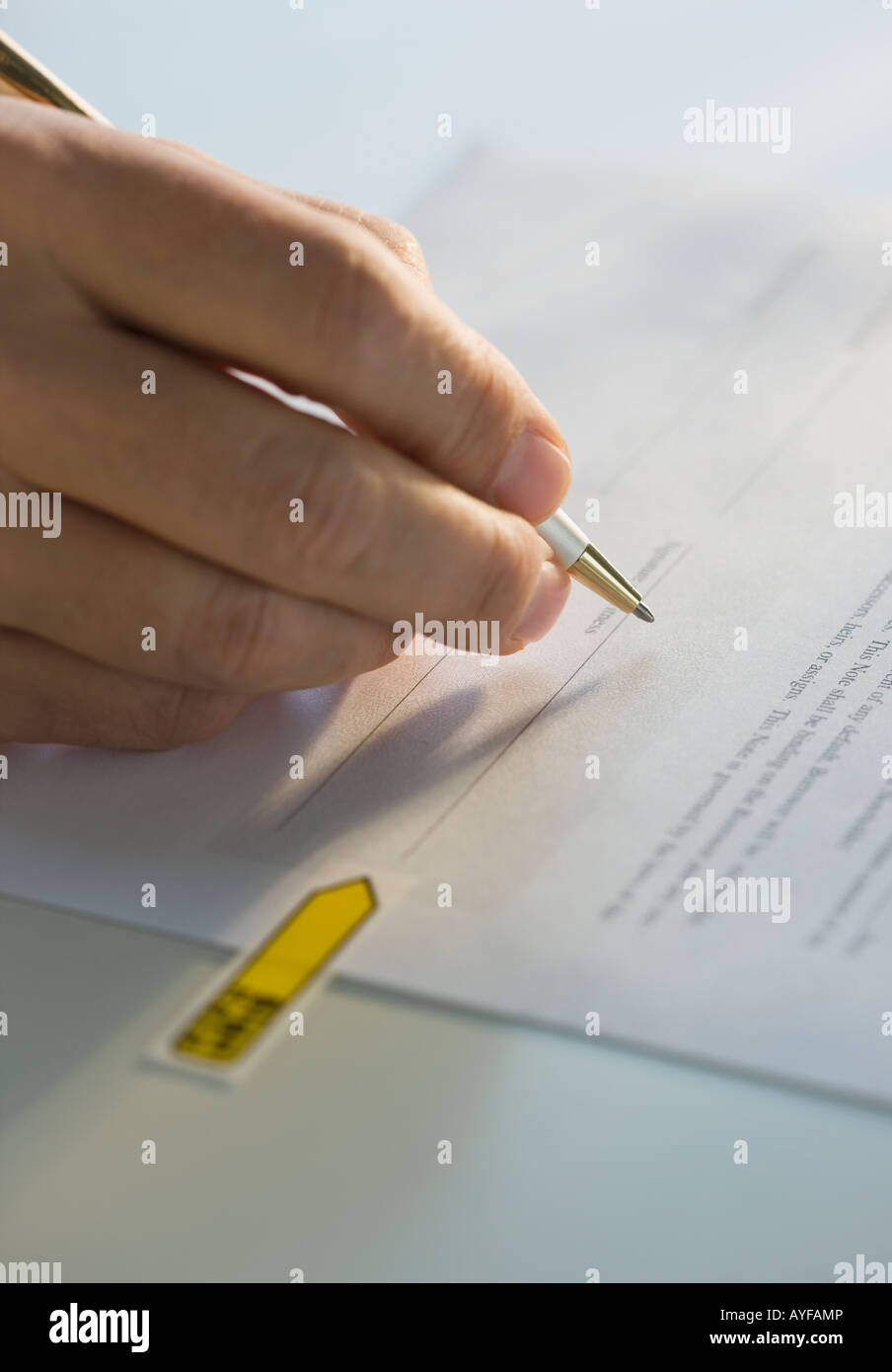 Close up of man signing paperwork Stock Photo - Alamy