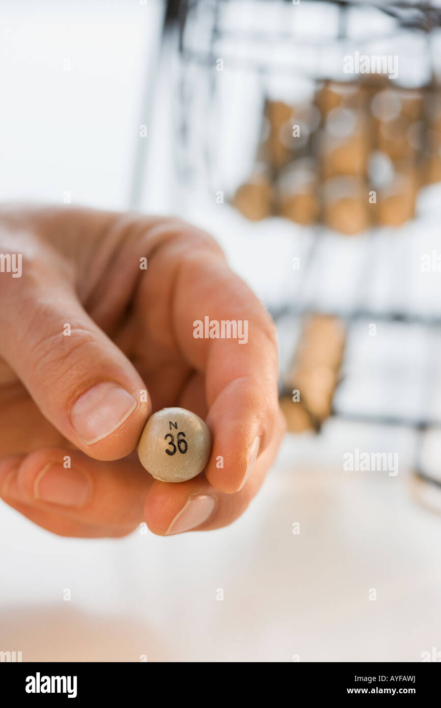 Man holding bingo ball Stock Photo - Alamy
