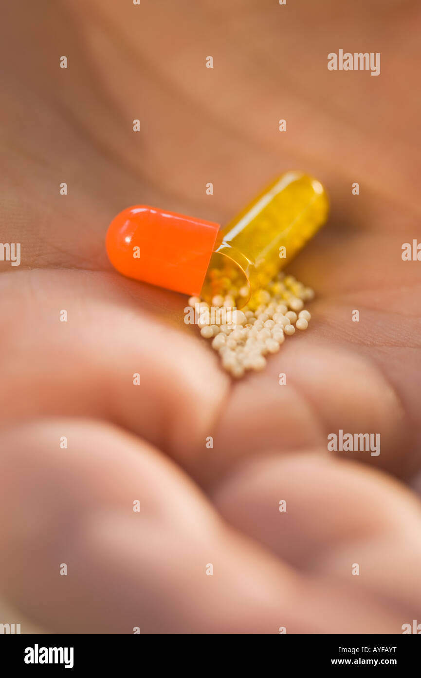 Close up of open medication capsule in man’s hand Stock Photo - Alamy