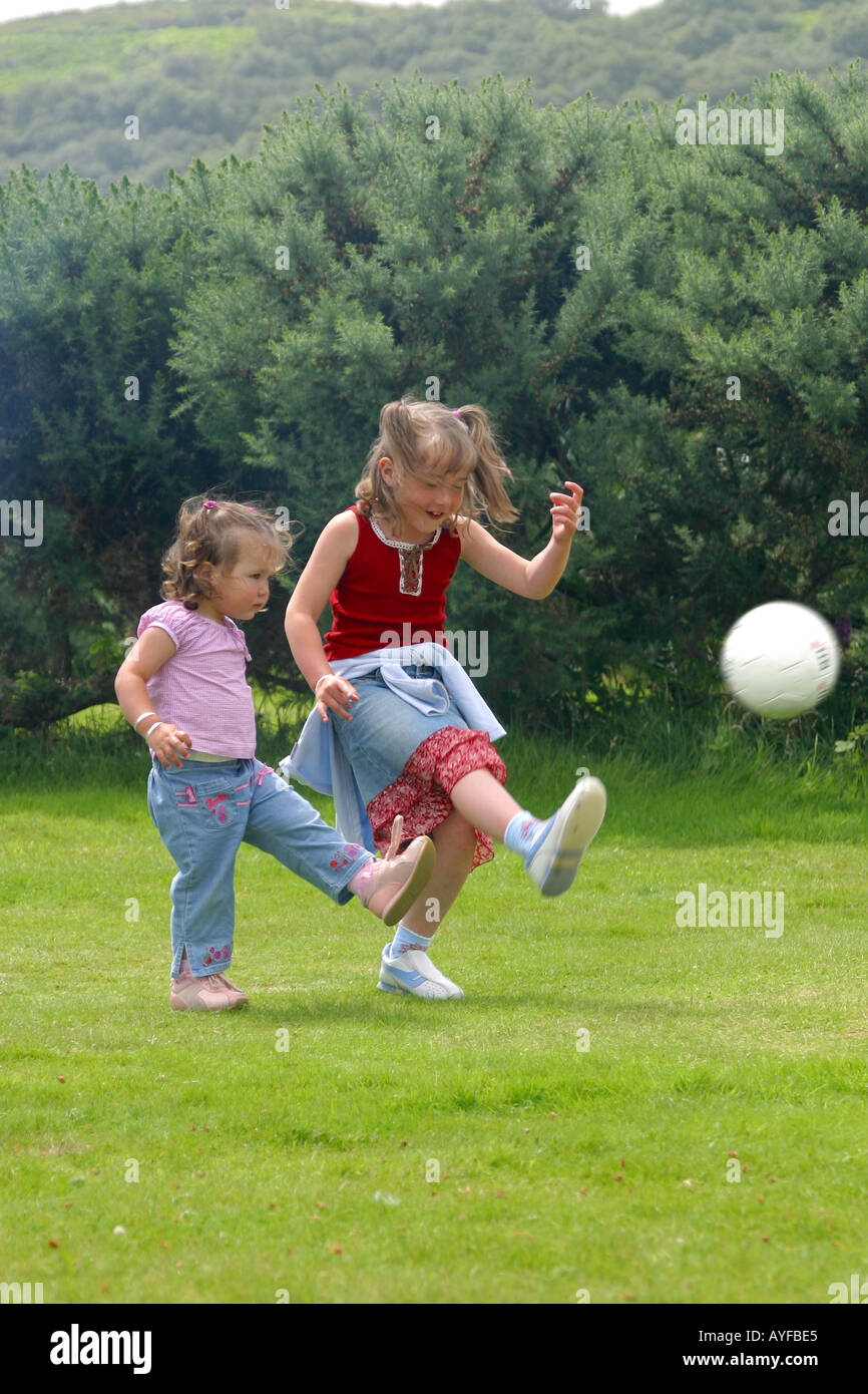 Two young girls playing football Stock Photo - Alamy