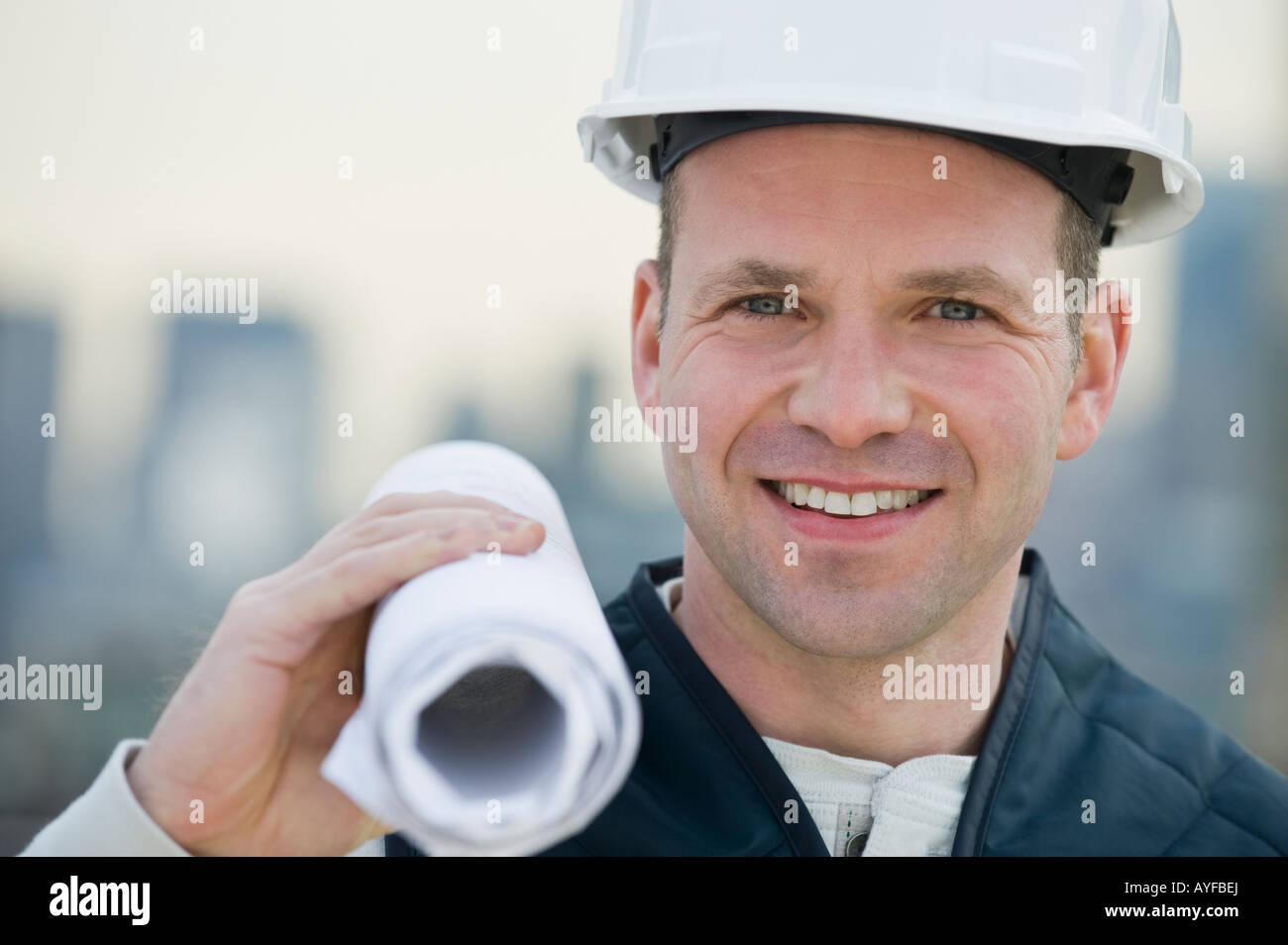 Male construction worker holding blueprints Stock Photo - Alamy