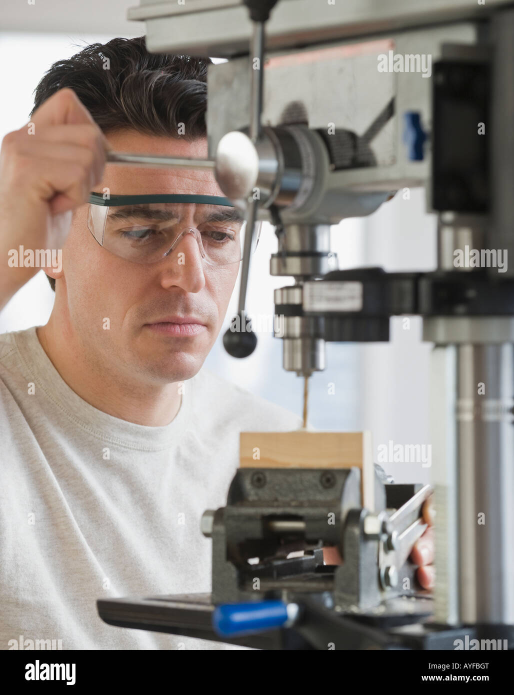 Man using drill press Stock Photo - Alamy