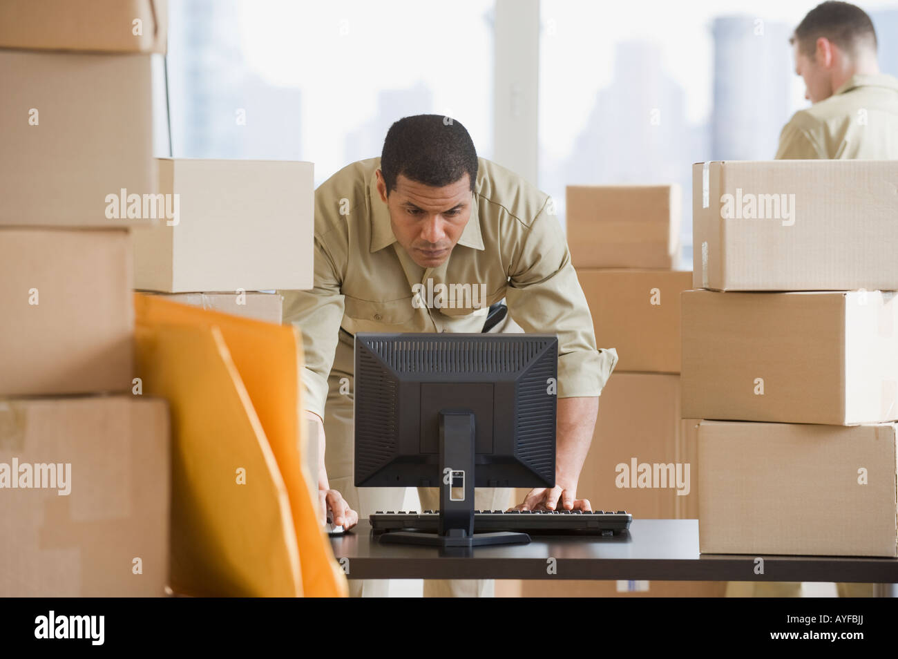 African delivery man looking at computer Stock Photo - Alamy