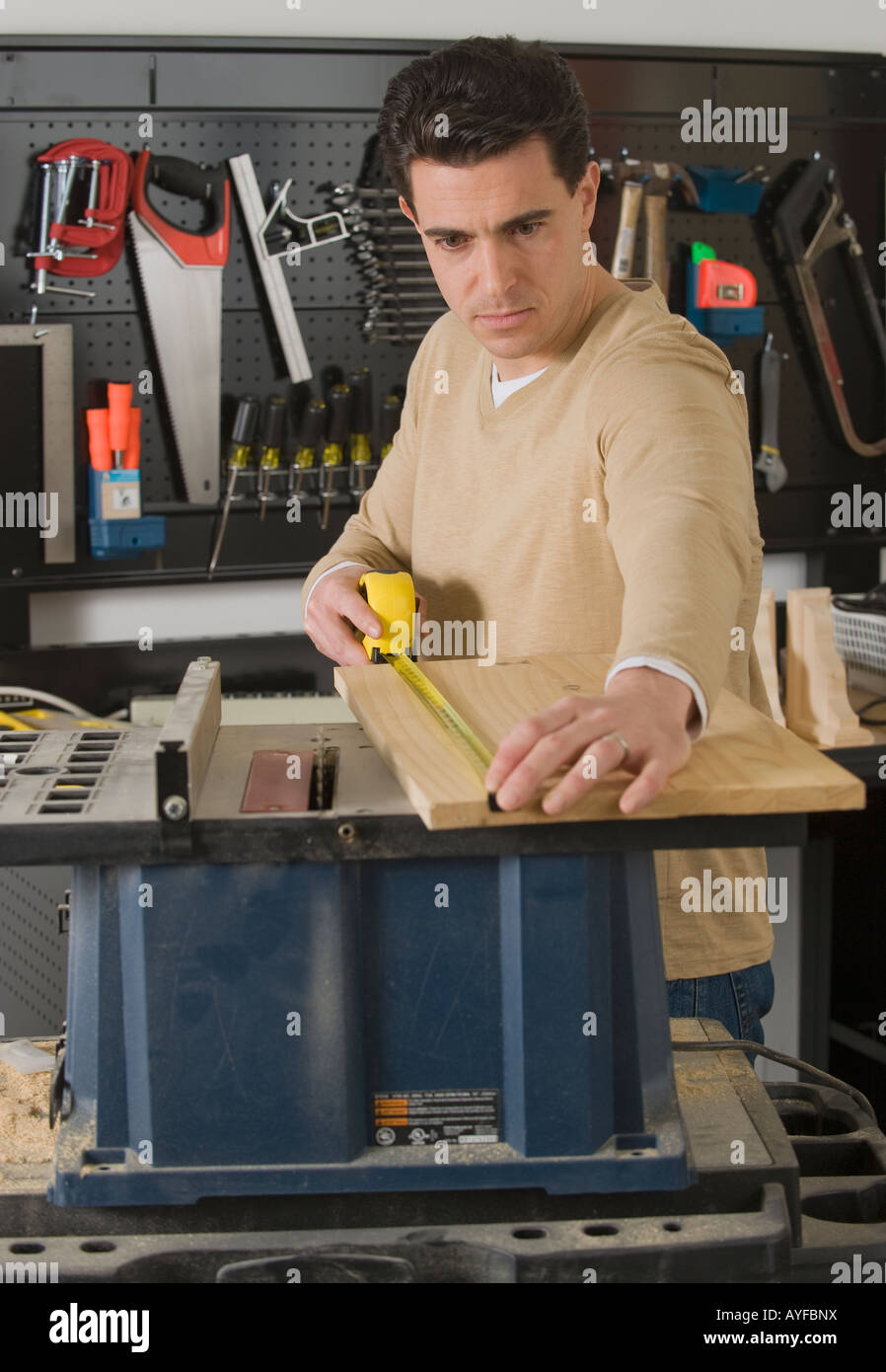 Male woodworker measuring piece of wood Stock Photo - Alamy