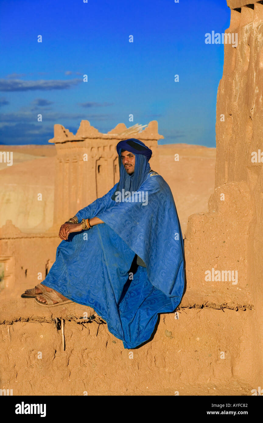 Tuareg man dressed in traditional clothing with Ait Benhaddou Kasbah in ...