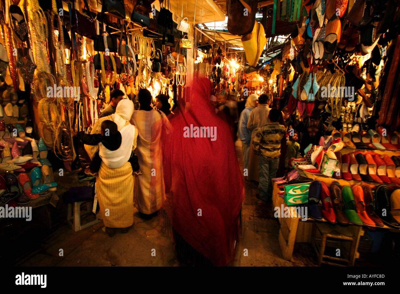 People shopping in the colourful winding maze of streets of the Souk ...