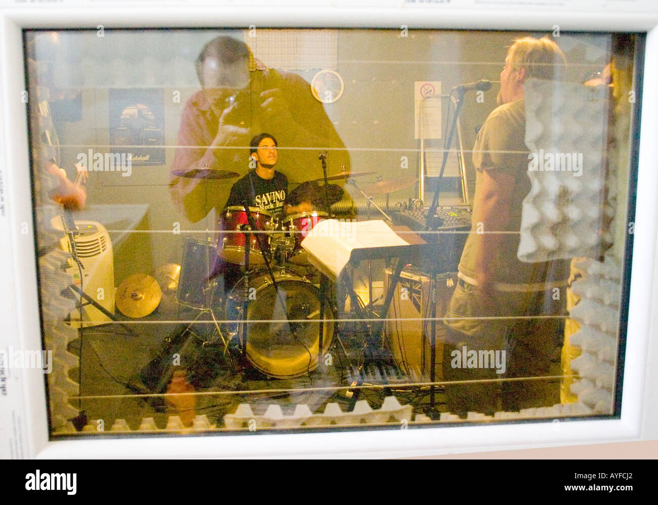 Reflection of photographer imaging band through practice room window of ...