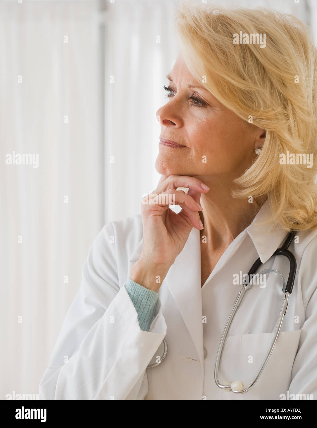 Female doctor thinking Stock Photo - Alamy
