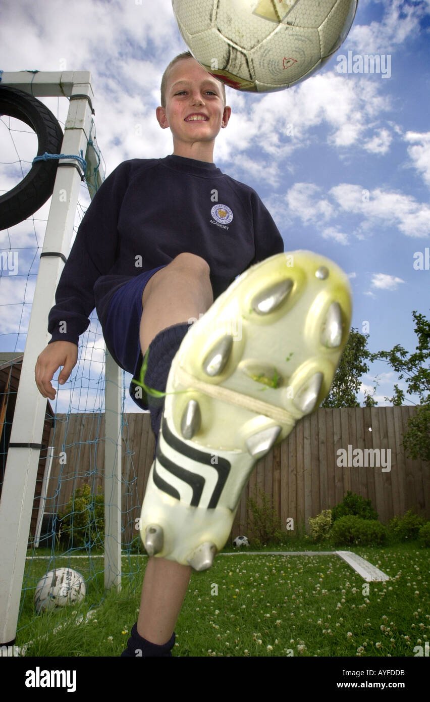 Boy playing football in england hi-res stock photography and images - Alamy