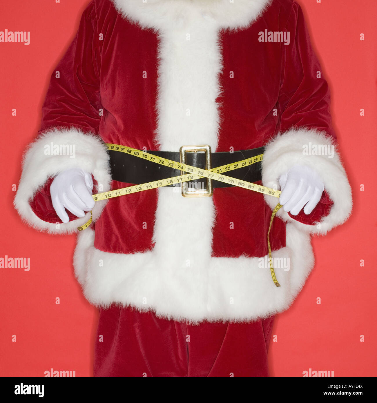 Santa Claus measuring waist with tape measure Stock Photo - Alamy