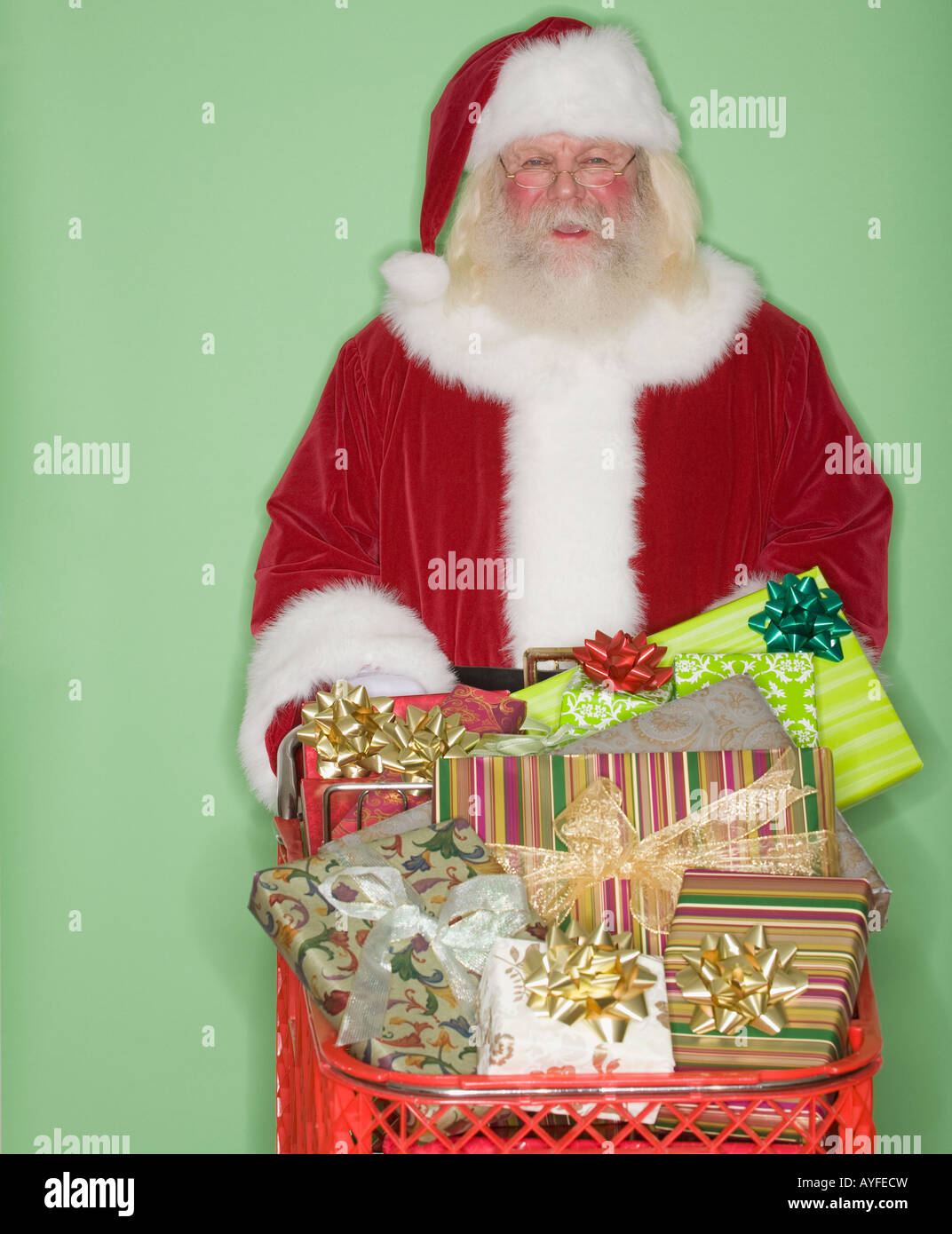 Santa Claus pushing shopping cart of gifts Stock Photo - Alamy