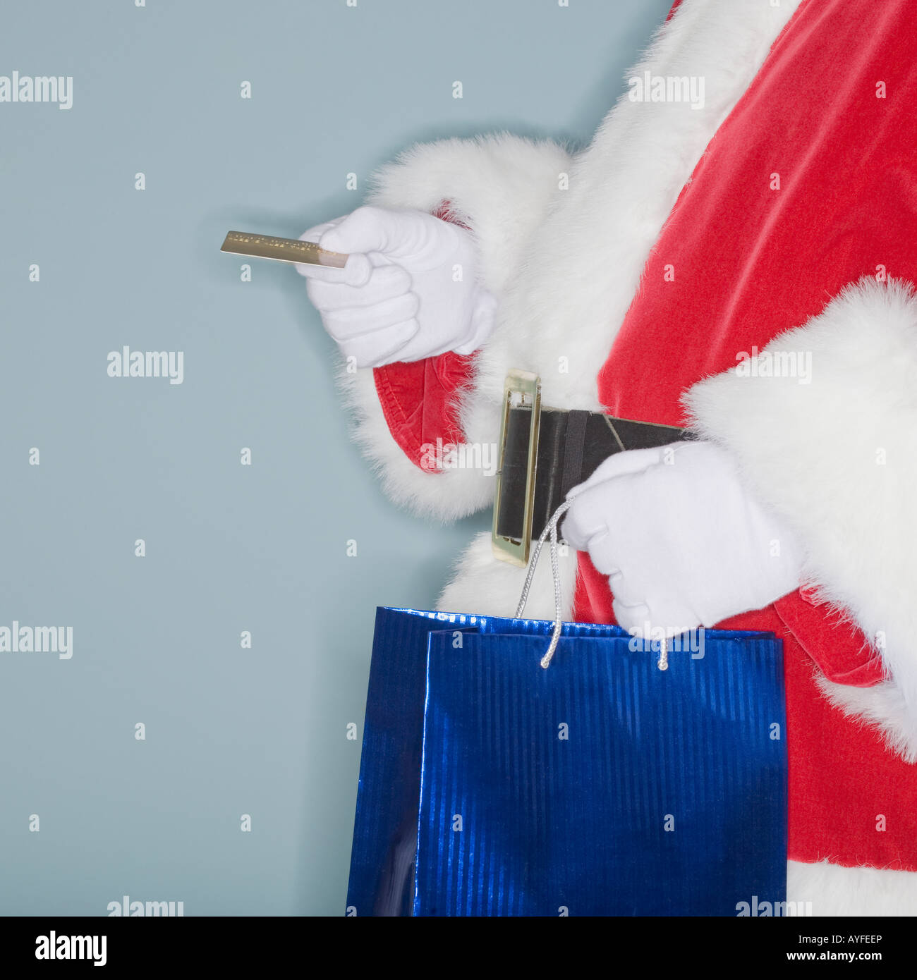 Santa Claus holding shopping bag and credit card Stock Photo - Alamy