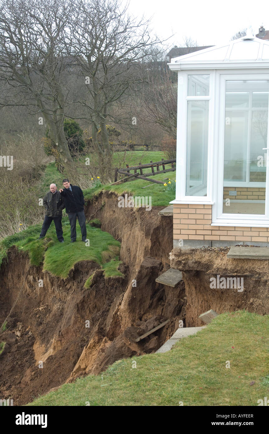 Residents looking down from cliff landslide debris at Knipe Point ...