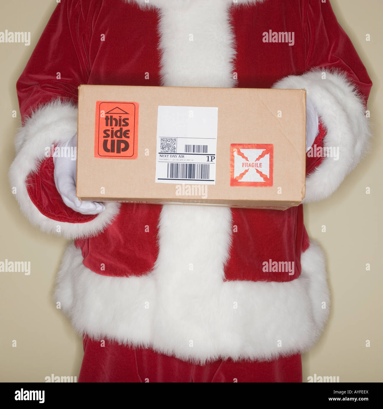 Santa Claus holding package Stock Photo - Alamy