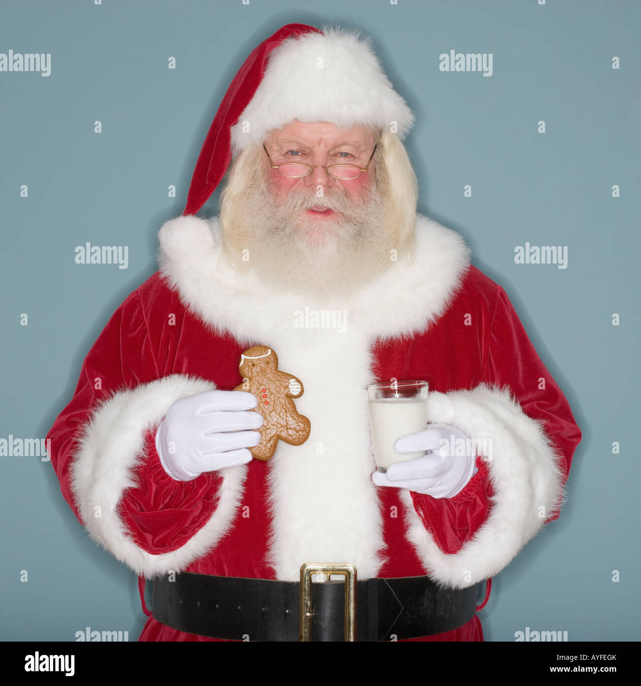 Santa Claus holding cookie and milk Stock Photo - Alamy