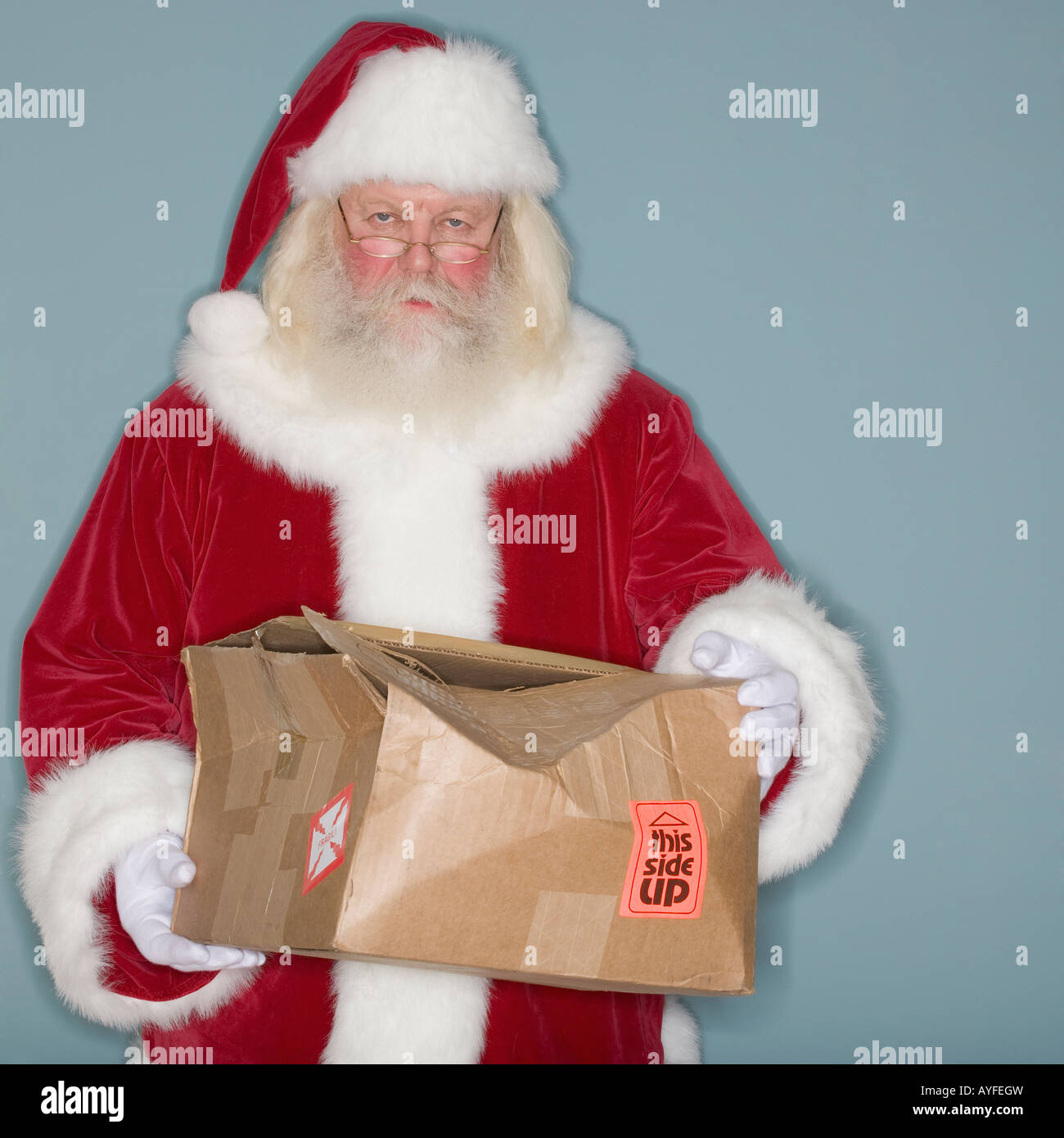 Santa Claus holding damaged box Stock Photo - Alamy
