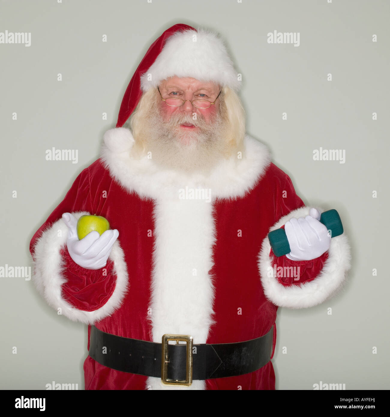 Santa Claus holding apple and dumbbell Stock Photo - Alamy