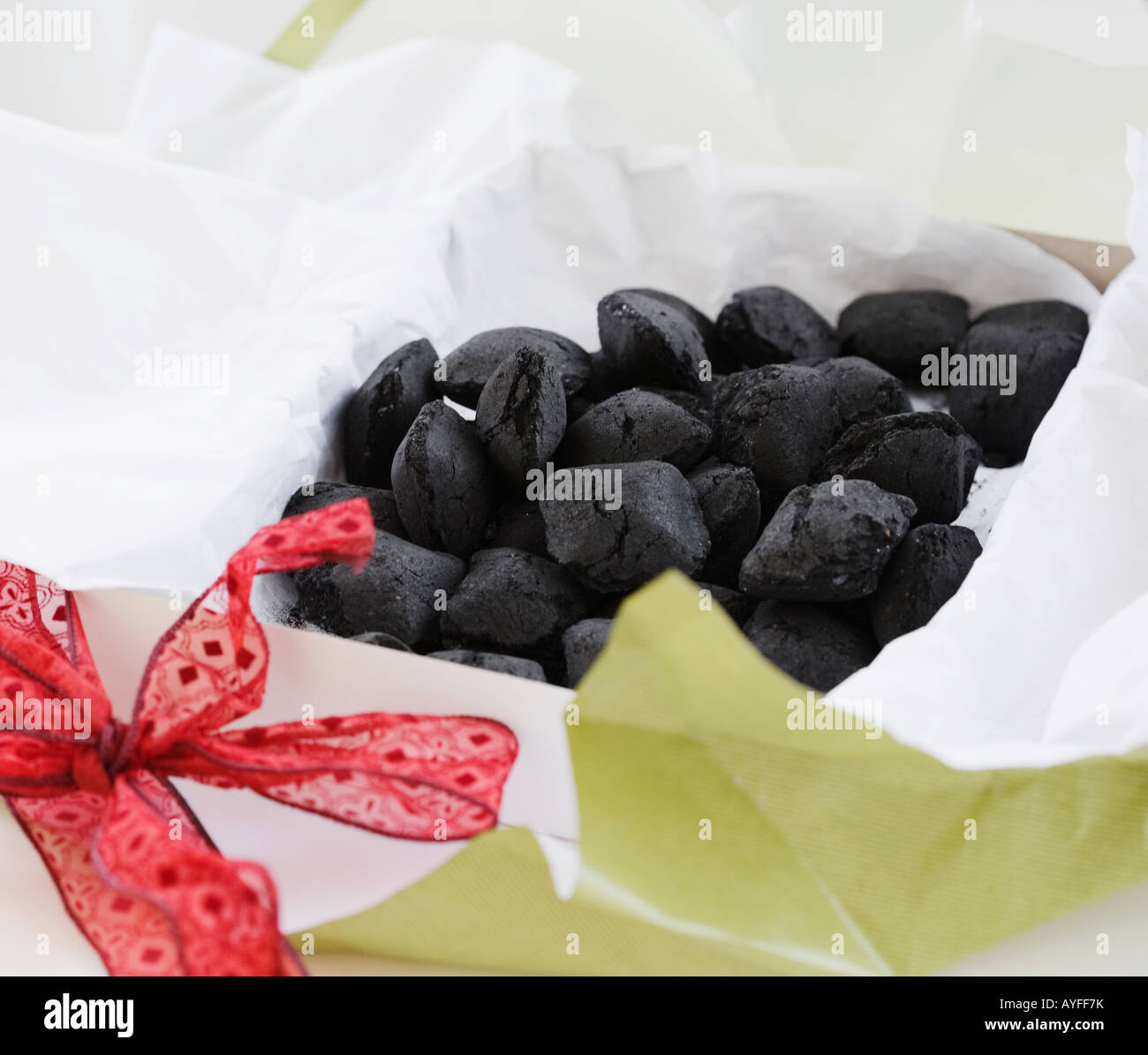 Pile of coal in gift box Stock Photo - Alamy