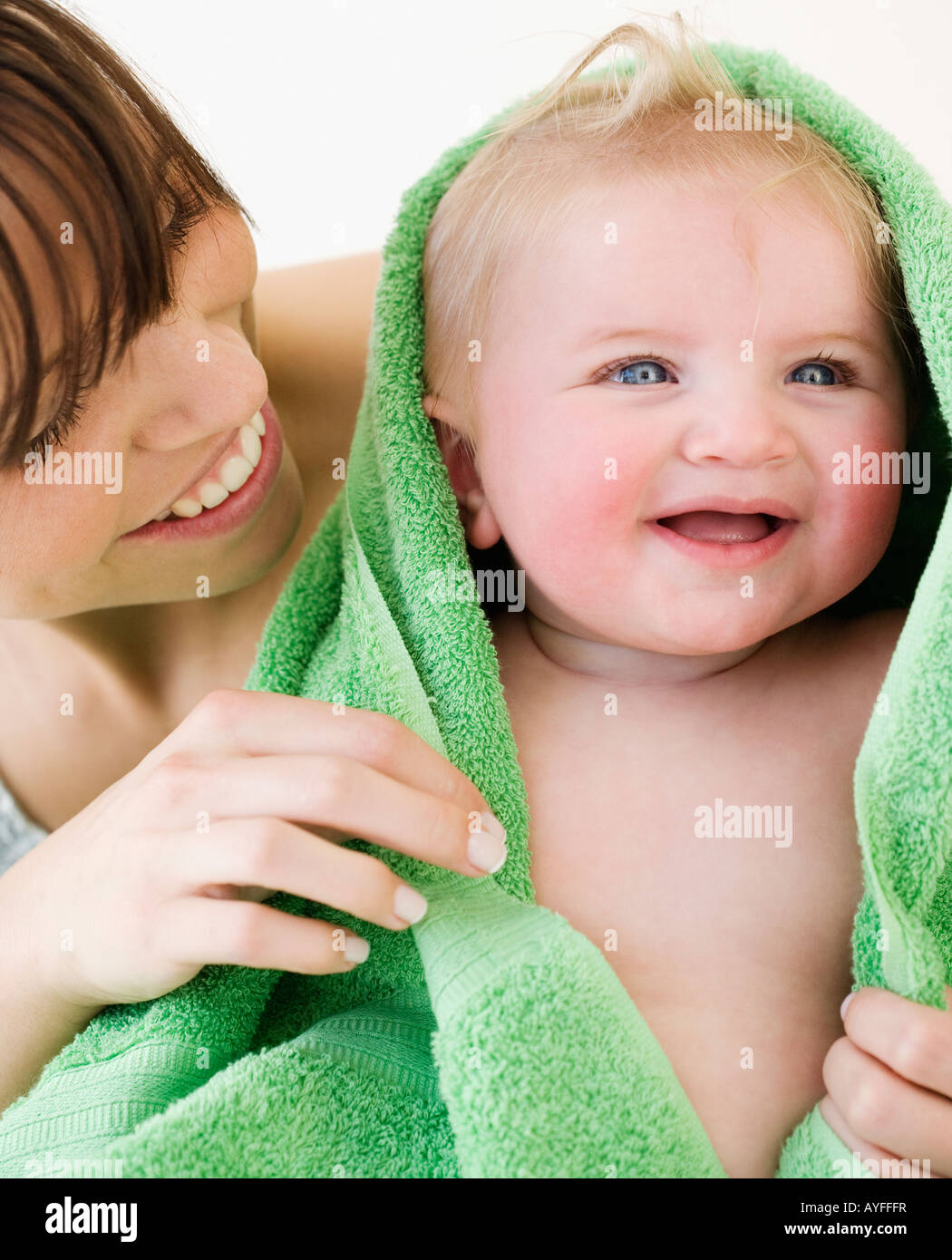 Mother drying baby with towel Stock Photo - Alamy