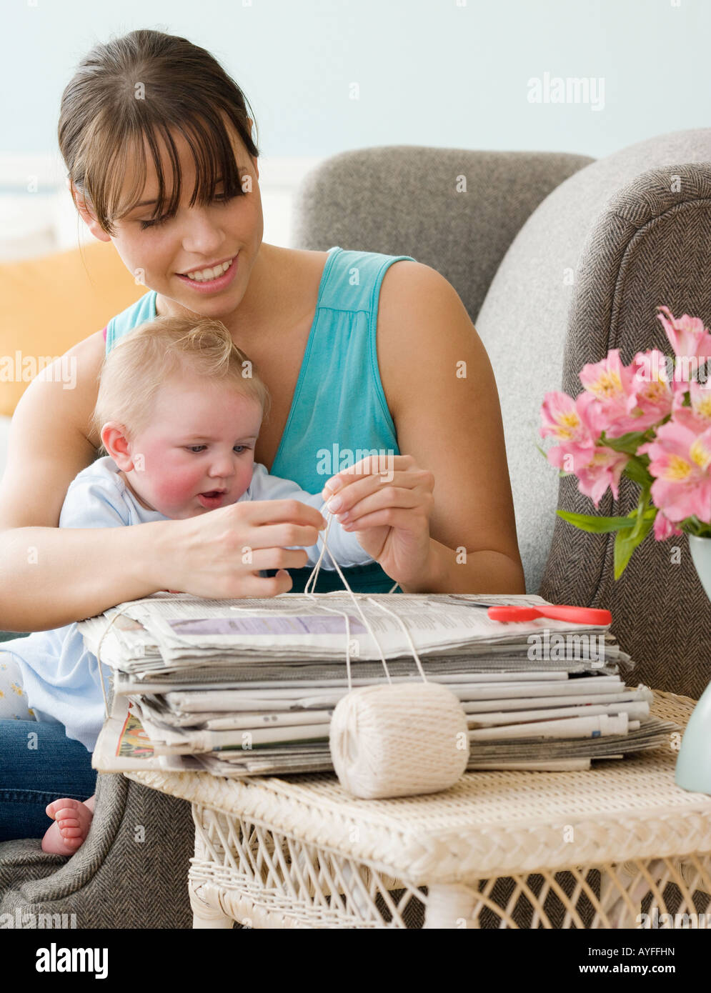 Mother and baby bundling newspapers Stock Photo - Alamy