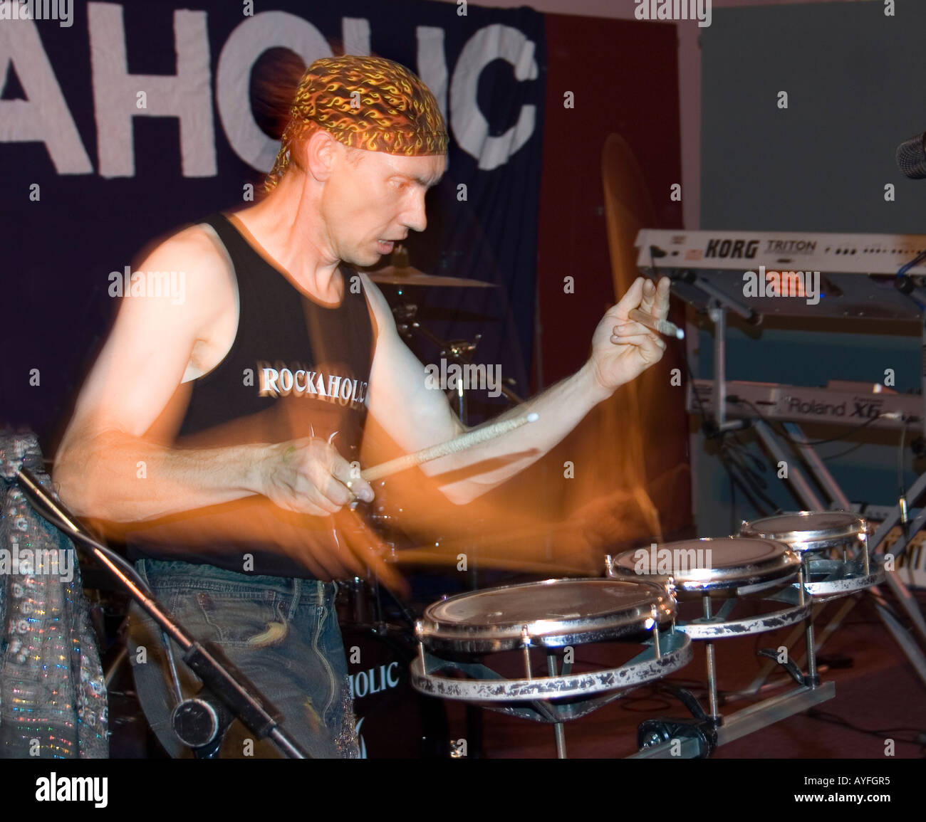 Nigel Atkins lead singer of rock tribute band Rockaholic drumming at a ...