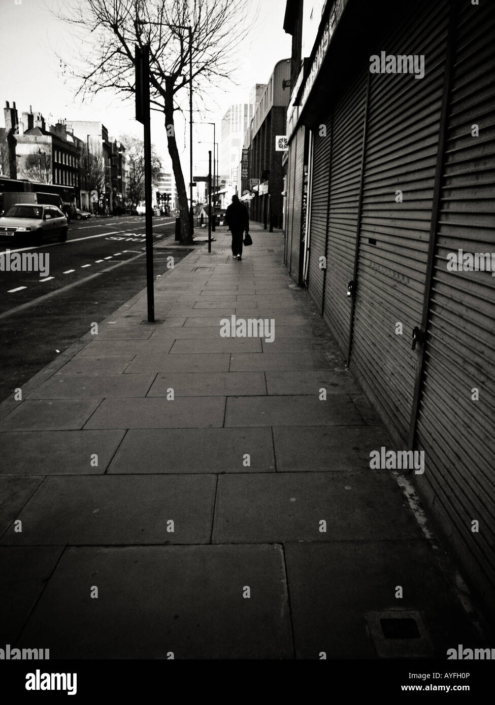 Lone pedestrian on Whitechapel Road, London, E1 Stock Photo - Alamy