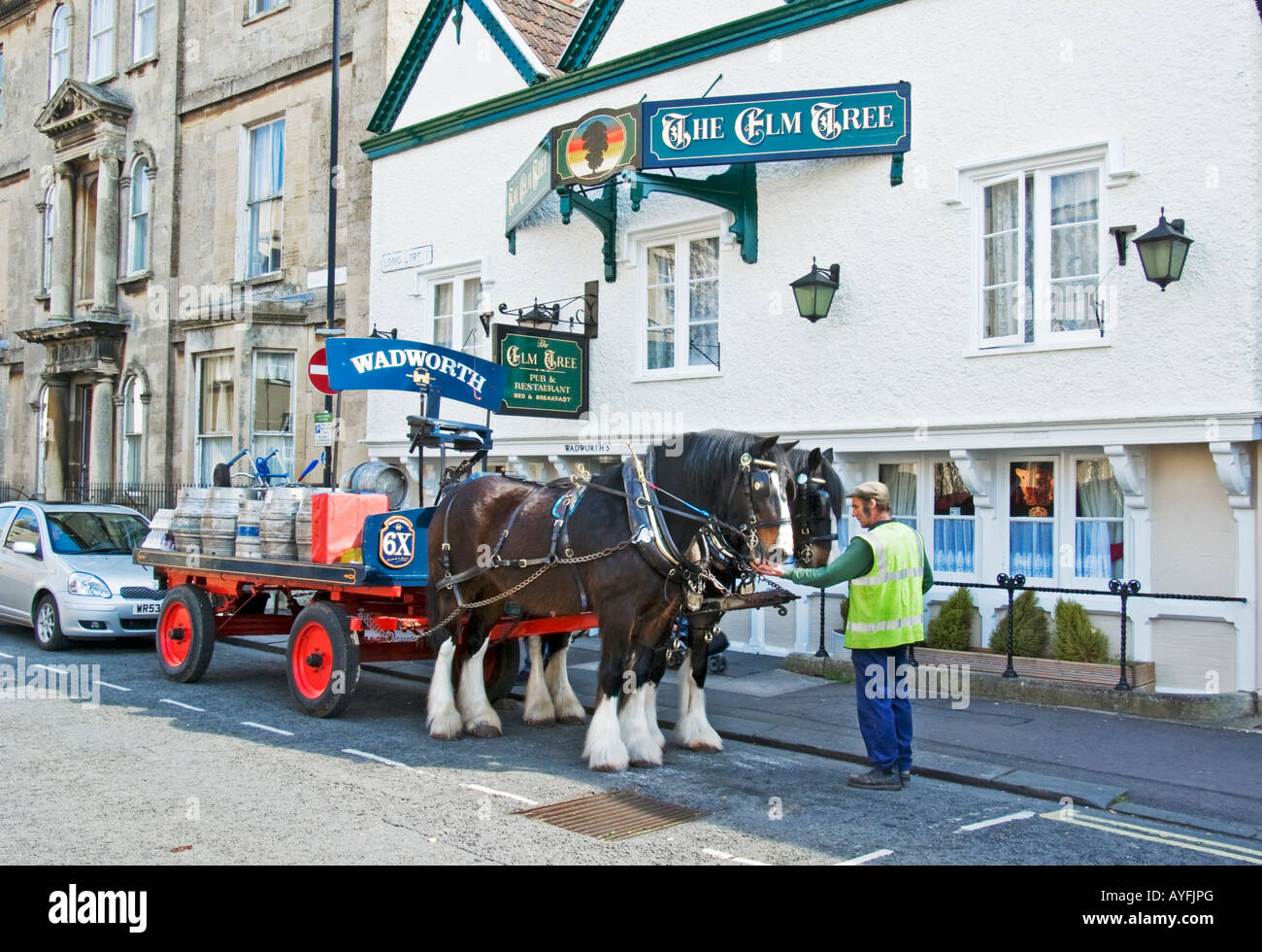 Two heavy Shire horses draw a beer dray around Devizes delivering local ...