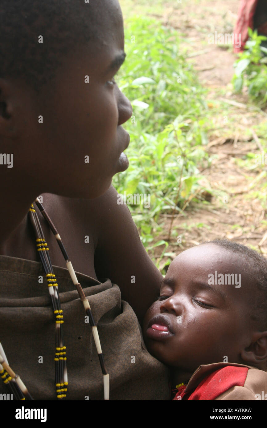 Africa Tanzania Lake Eyasi Portrait of a young Hadza mother with her ...