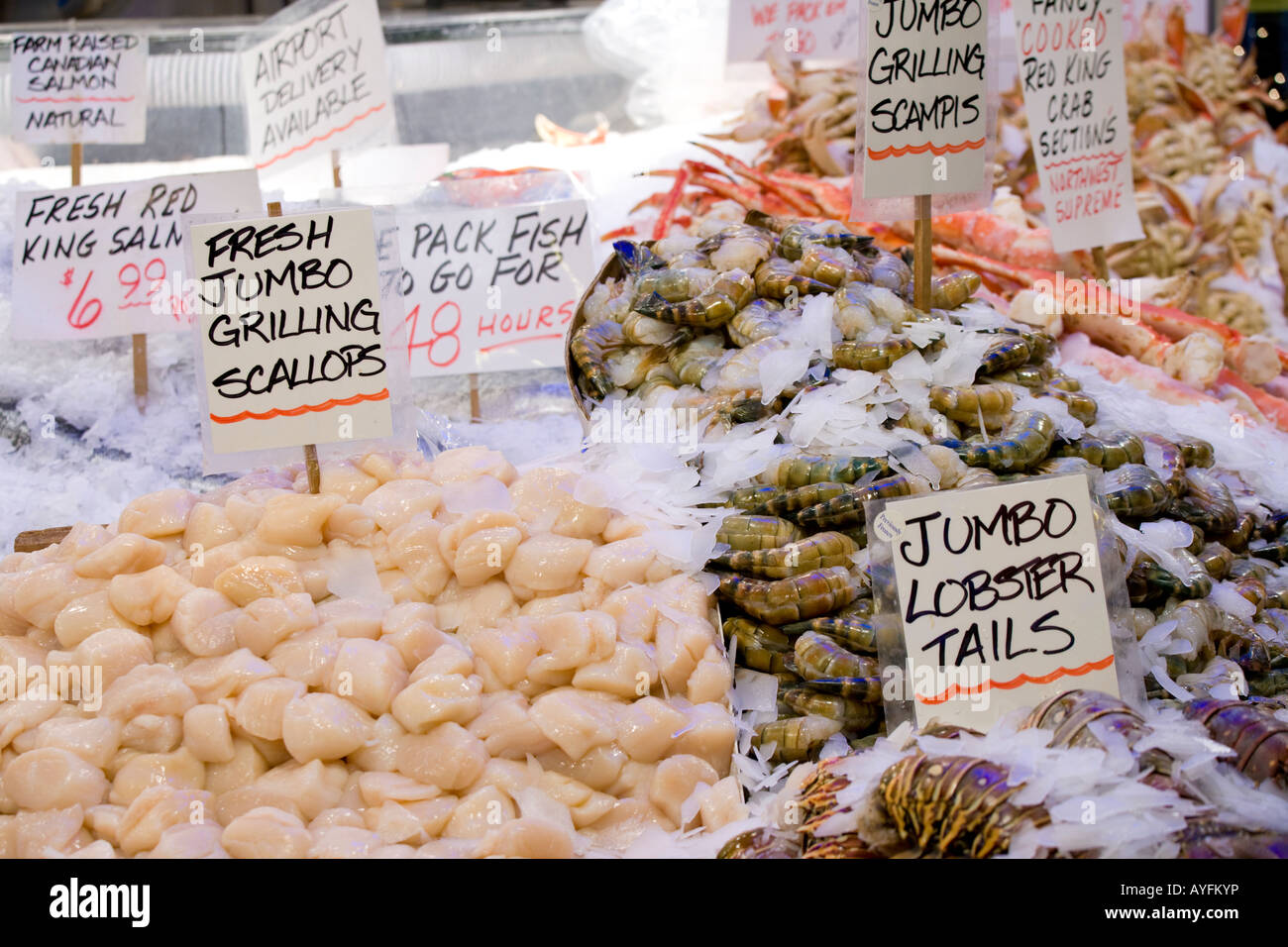 Closeup of shell fish prawns scallops and tags at Pike Place market in ...