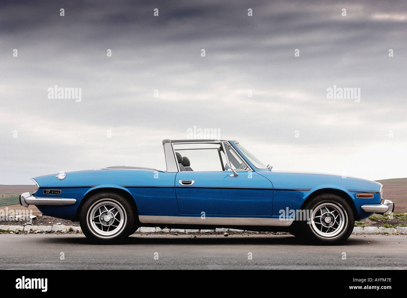 Blue Triumph Stag convertible car seen from the driver's side with a ...