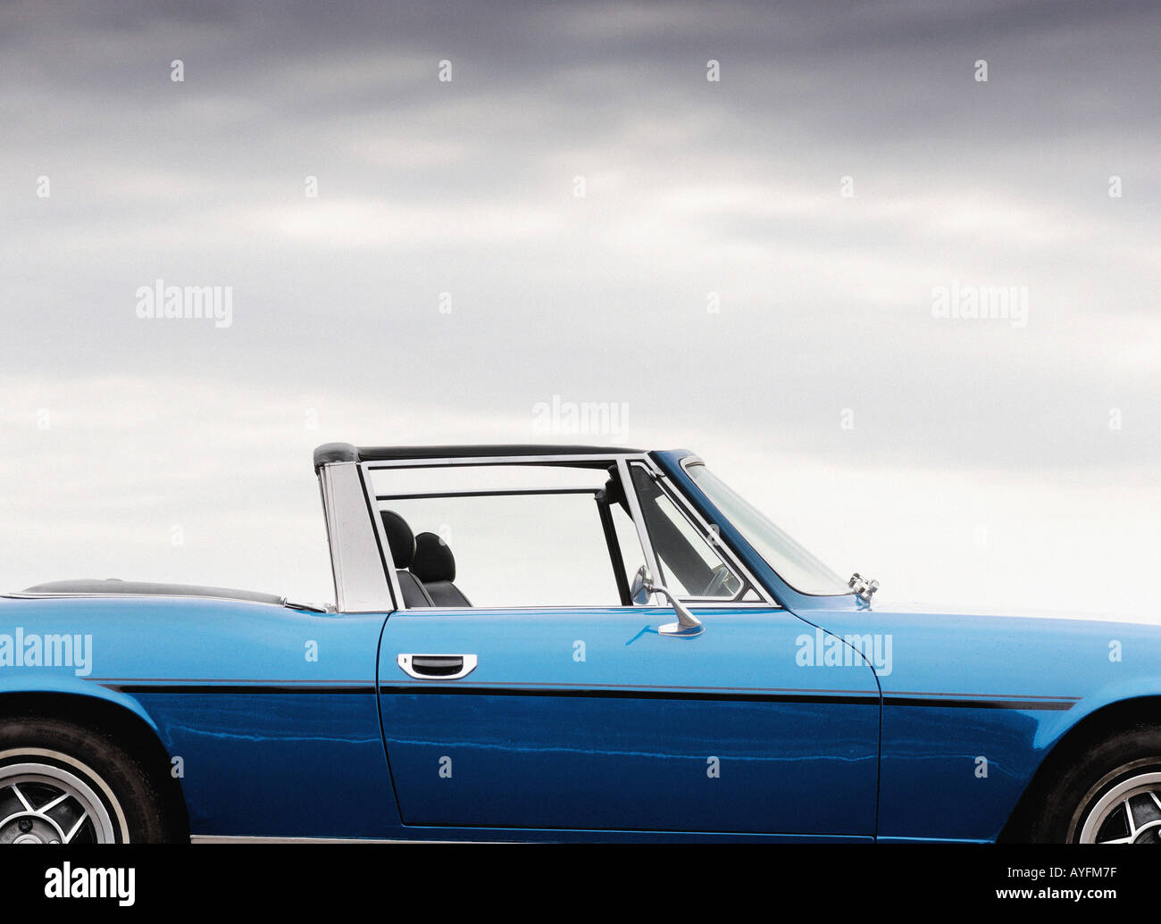 Blue Triumph Stag convertible car seen from the driver's side with a ...