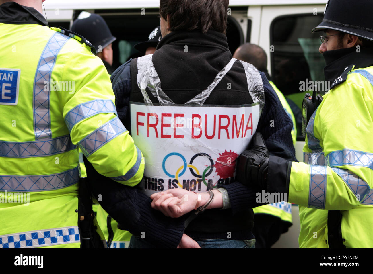 Police detain a human rights activist in London's Whitehall during anti ...