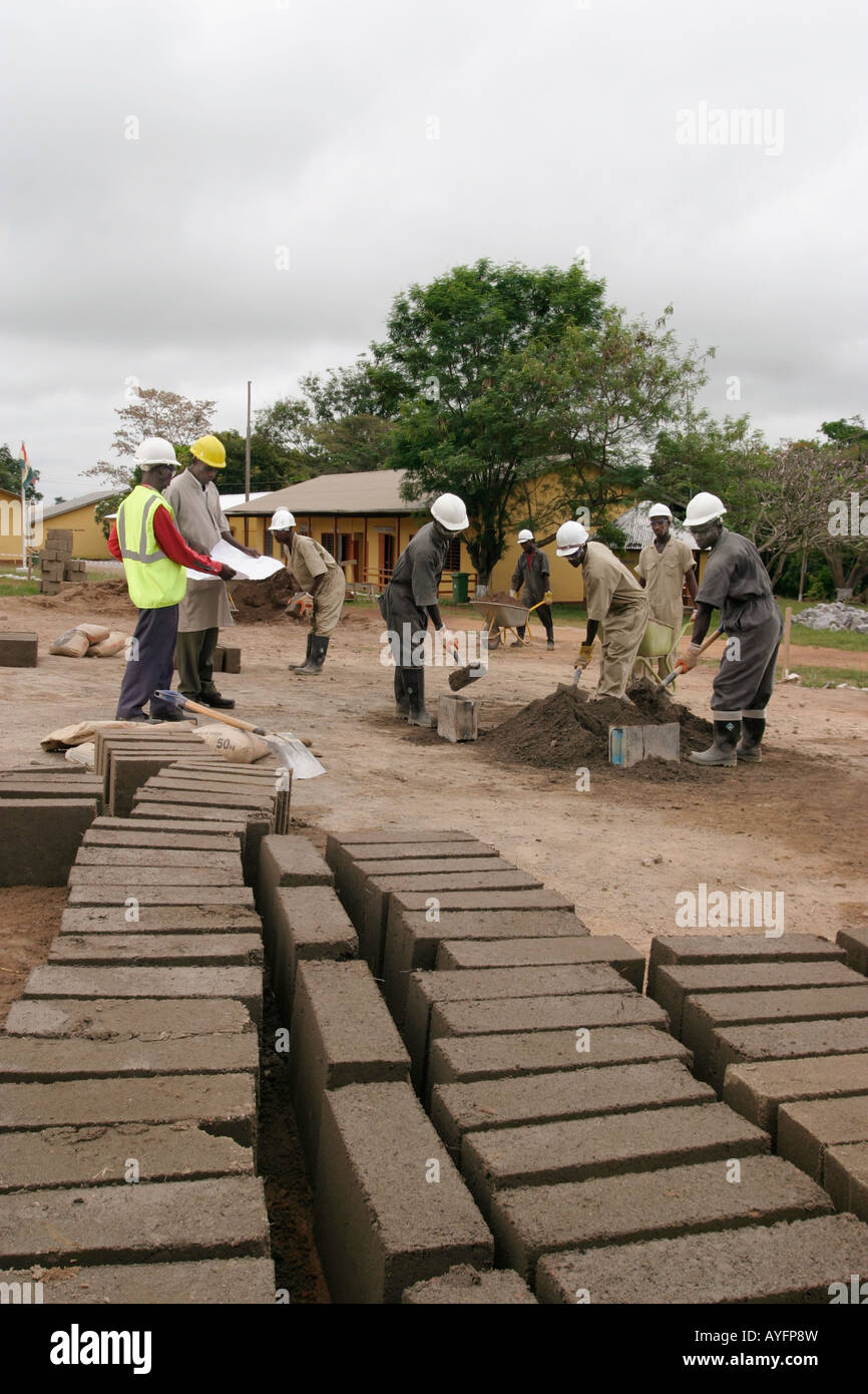 Construction workers discussing project while building village ...