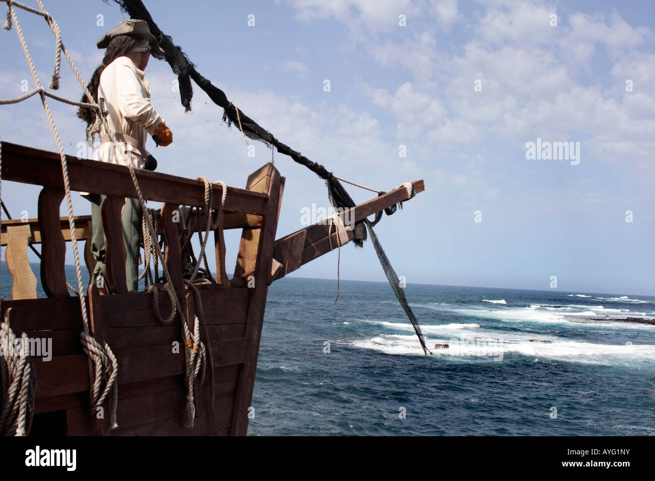 Pirate ship and captain keep watch over the Atlantic Ocean towards ...