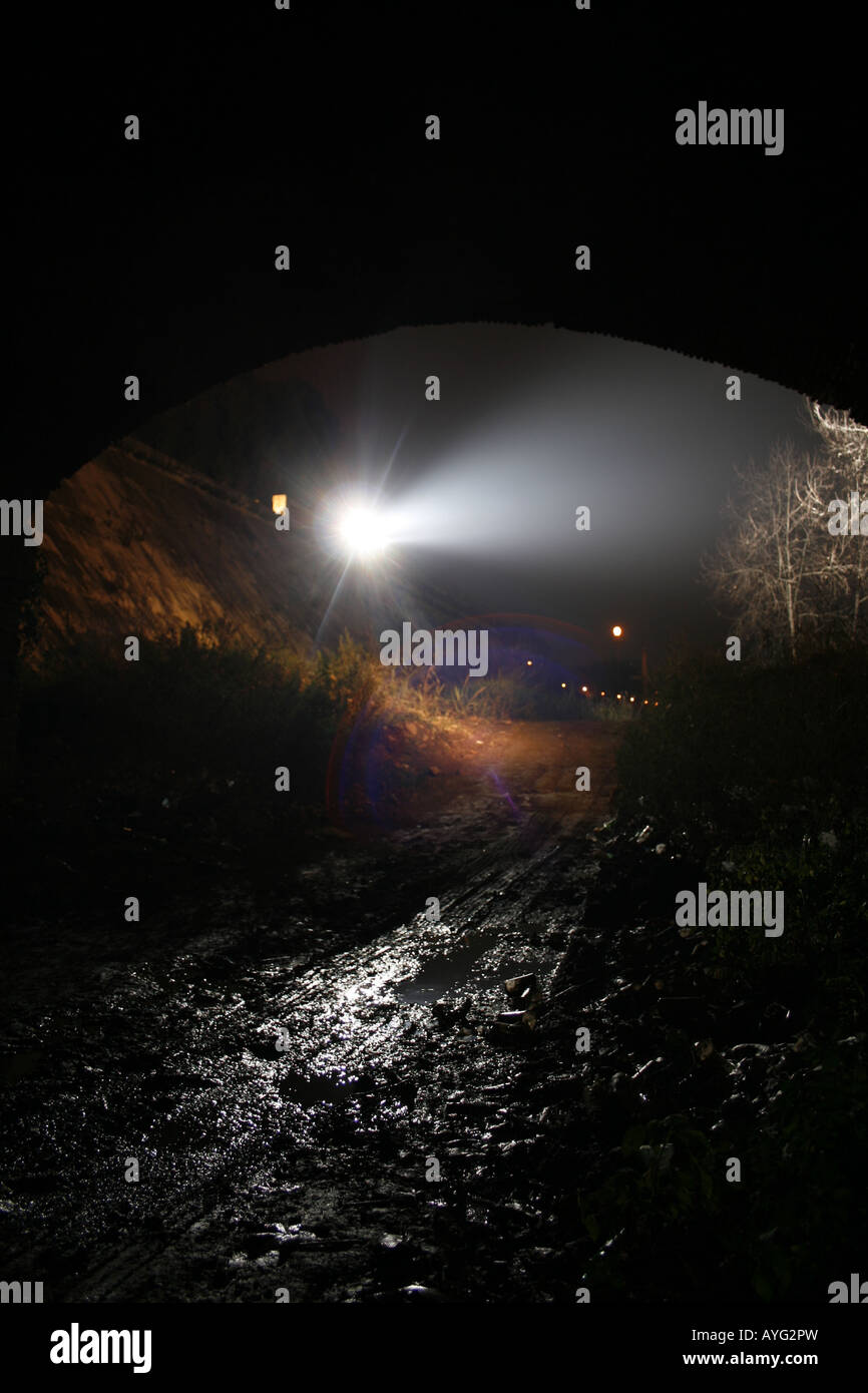 tyre tracks in mud under bridge at night Stock Photo - Alamy