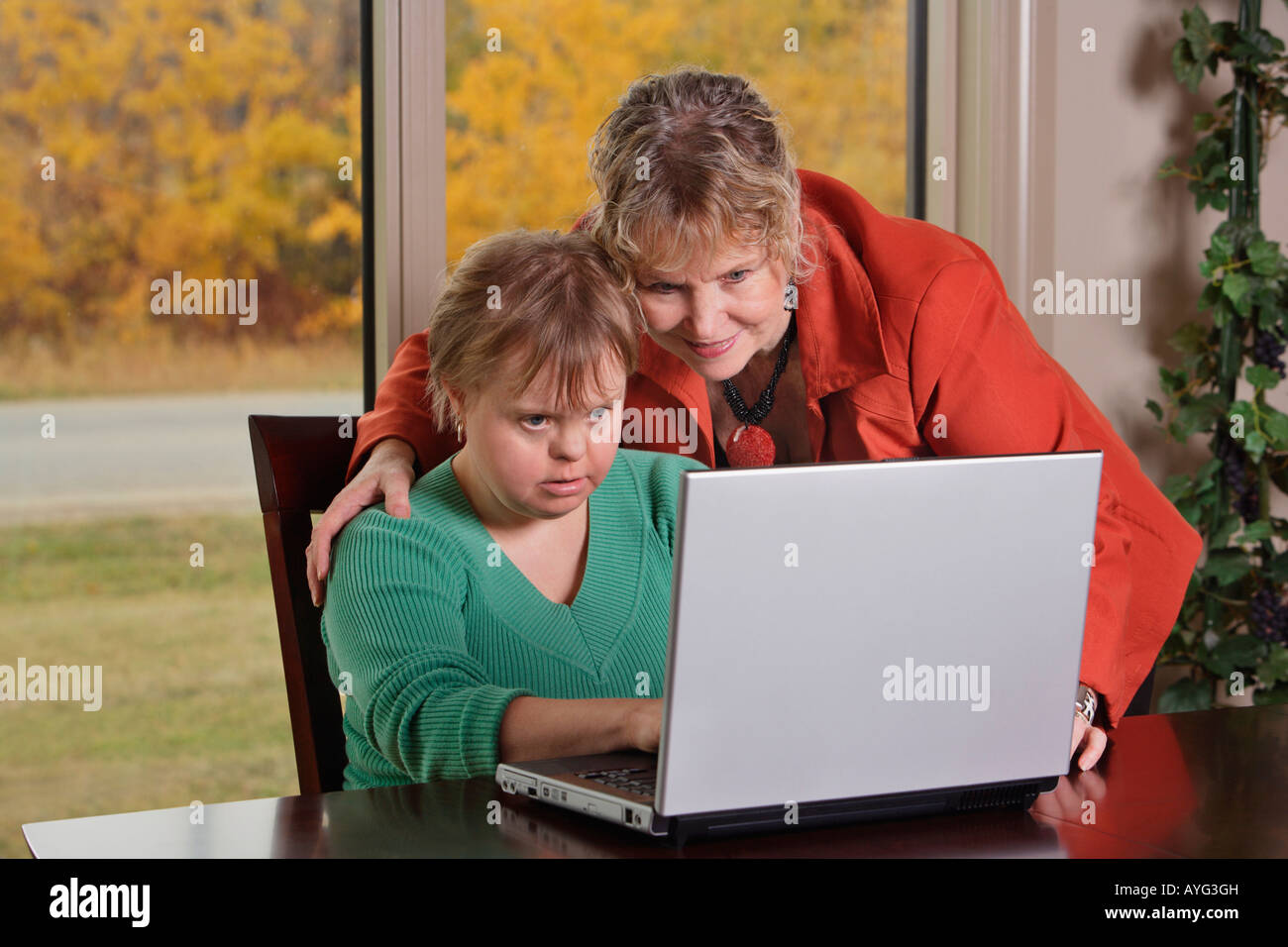 Mother and daughter with lap top computer Stock Photo - Alamy