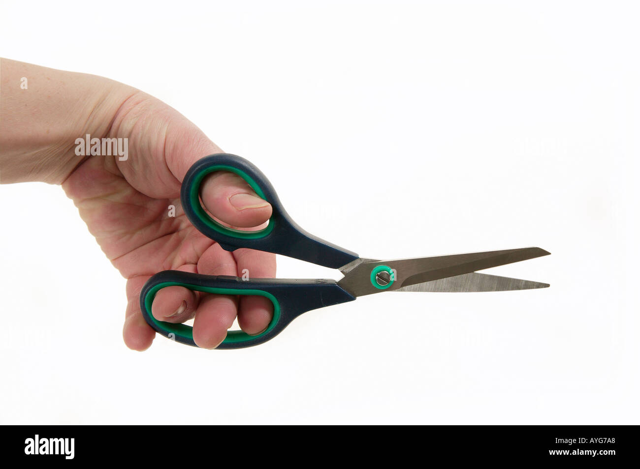 scissors held in hand horizontal pose with copyspace above and to the ...