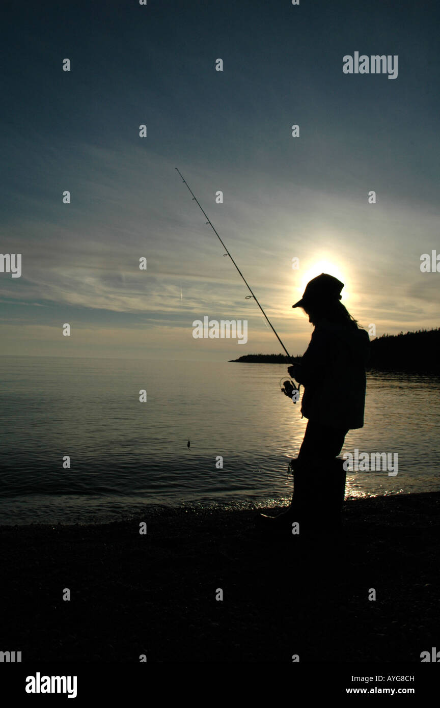 girl casting fishing lake superior shore line Stock Photo - Alamy