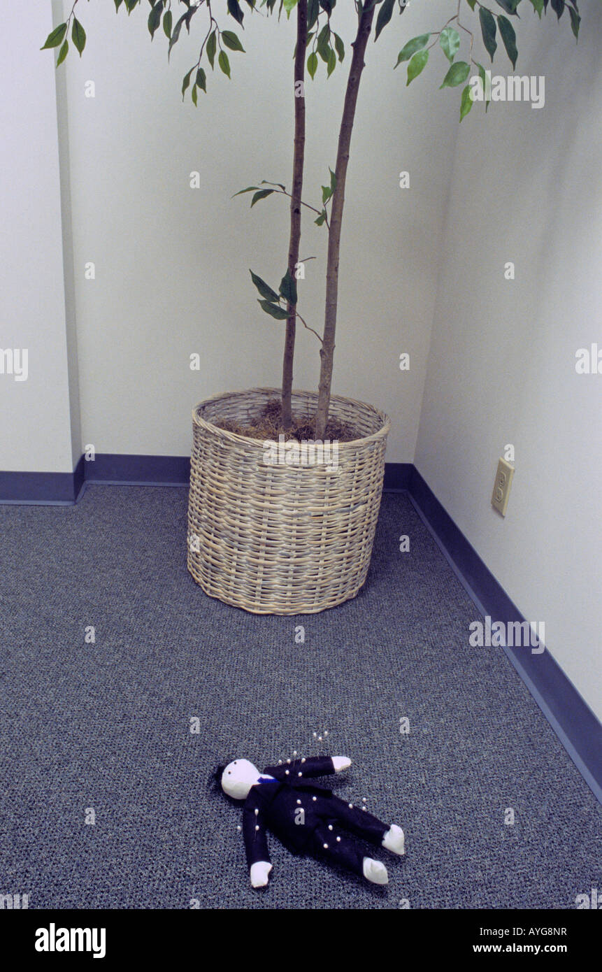 Voodoo doll lying on a carpet rug with plant in an office corridor ...