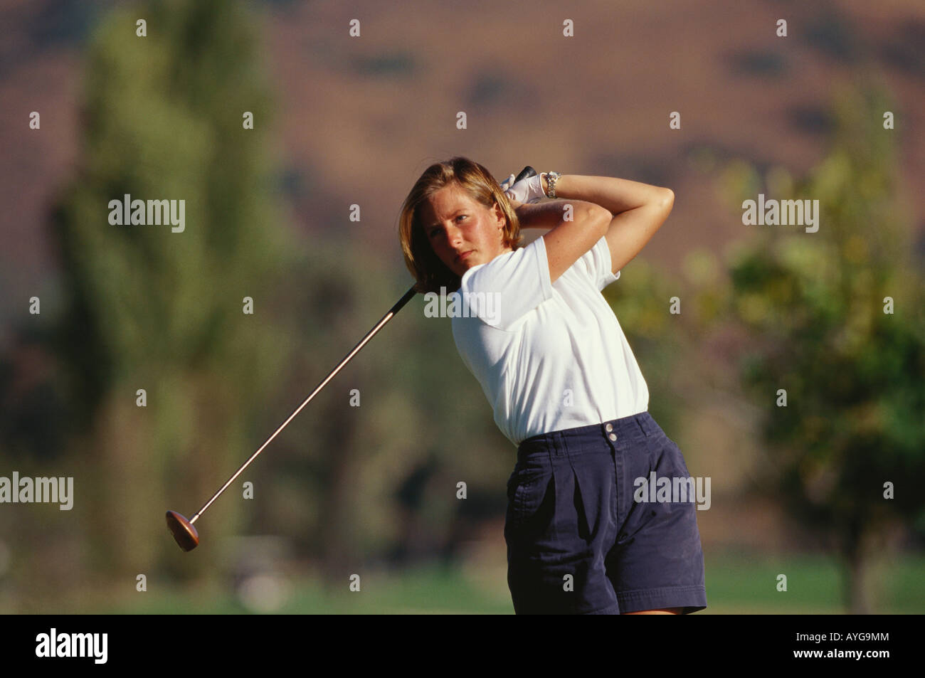 Woman golfer in action Stock Photo - Alamy