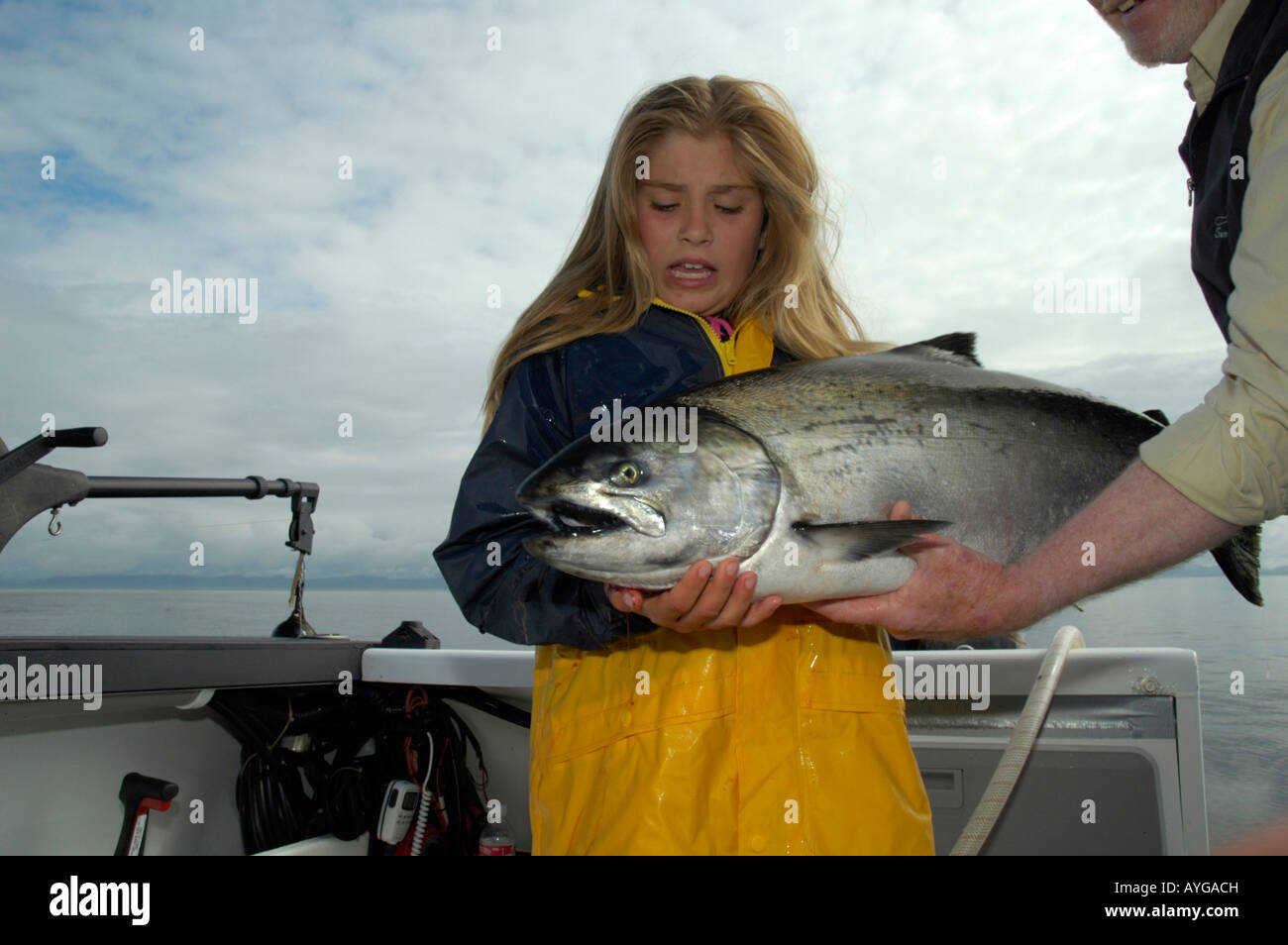 young girl holding big salmon Stock Photo - Alamy
