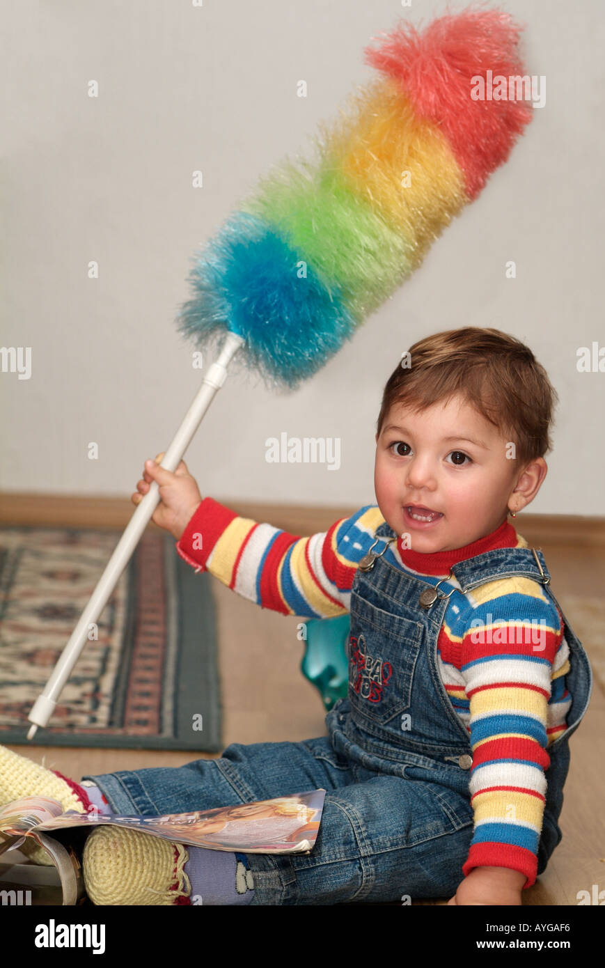 Small Child with a Feather Duster Stock Photo - Alamy