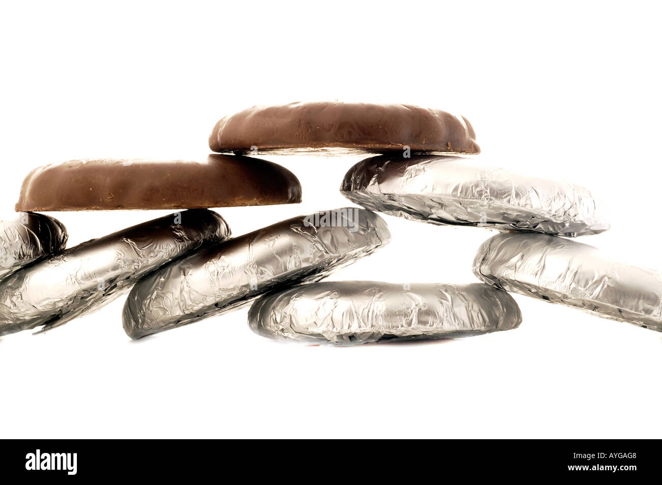 a selection of foil wrapped dark and milk chocolate round biscuits ...