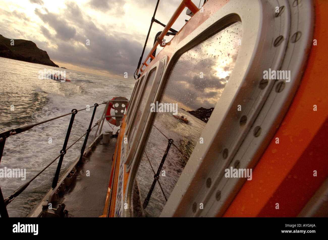 An RNLI rib reflected in lifeboat window at sunset off the North Devon ...