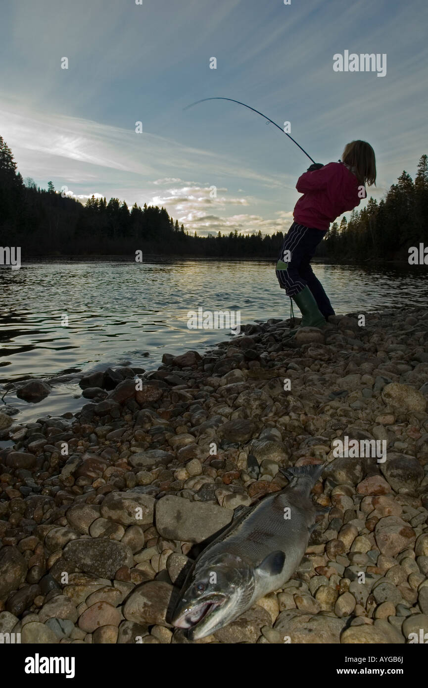 girl battling salmon in river Stock Photo - Alamy