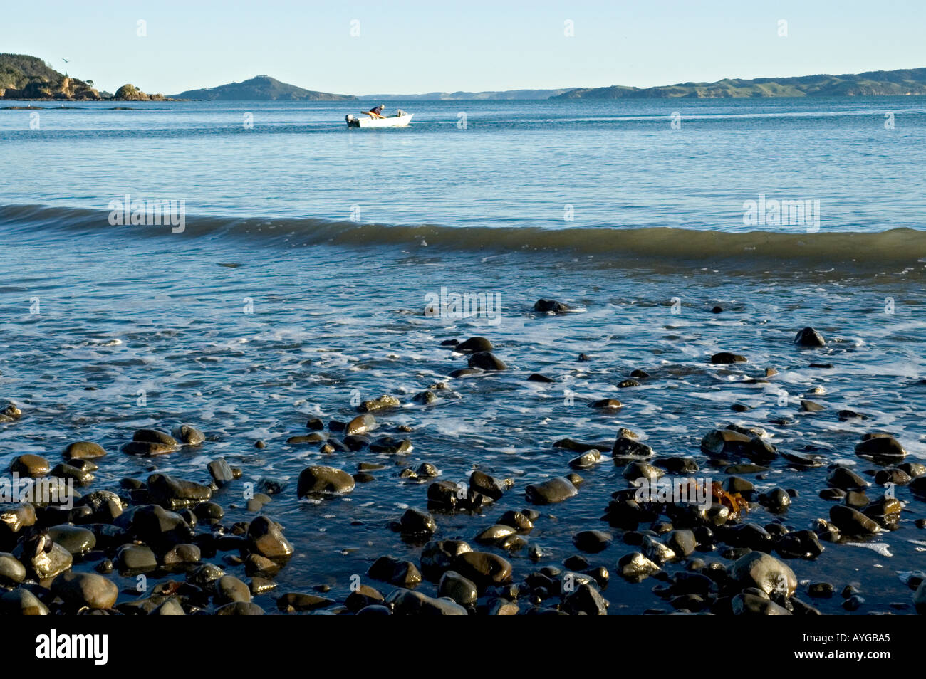 fisherman in boat Orere point Beach Stock Photo - Alamy