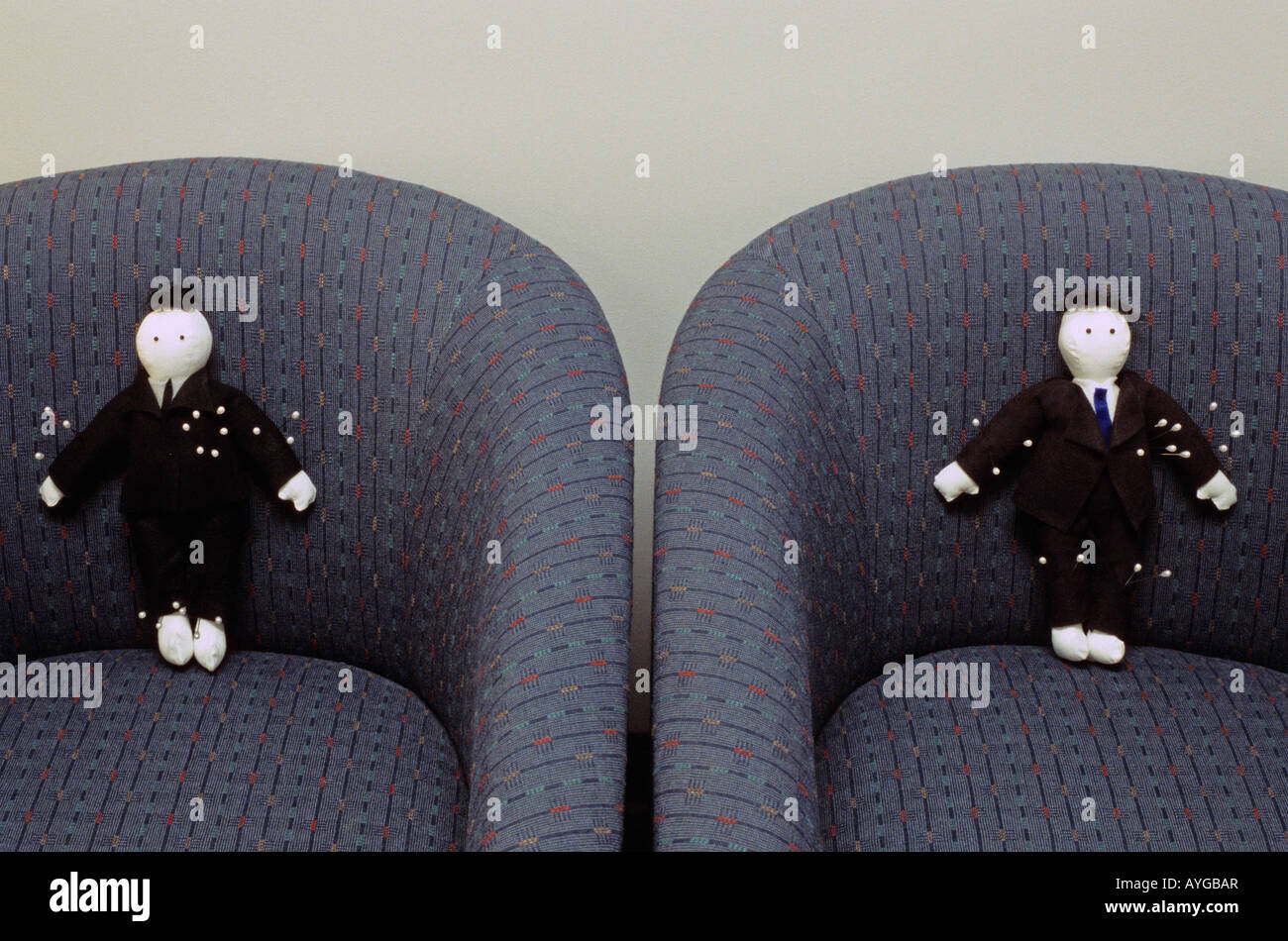Voodoo dolls standing in chairs in office lobby dressed as a business ...