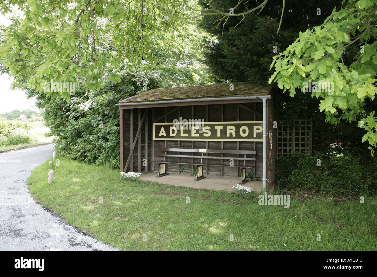 Bus shelter with the station sign and seat in the Cotswold village of ...