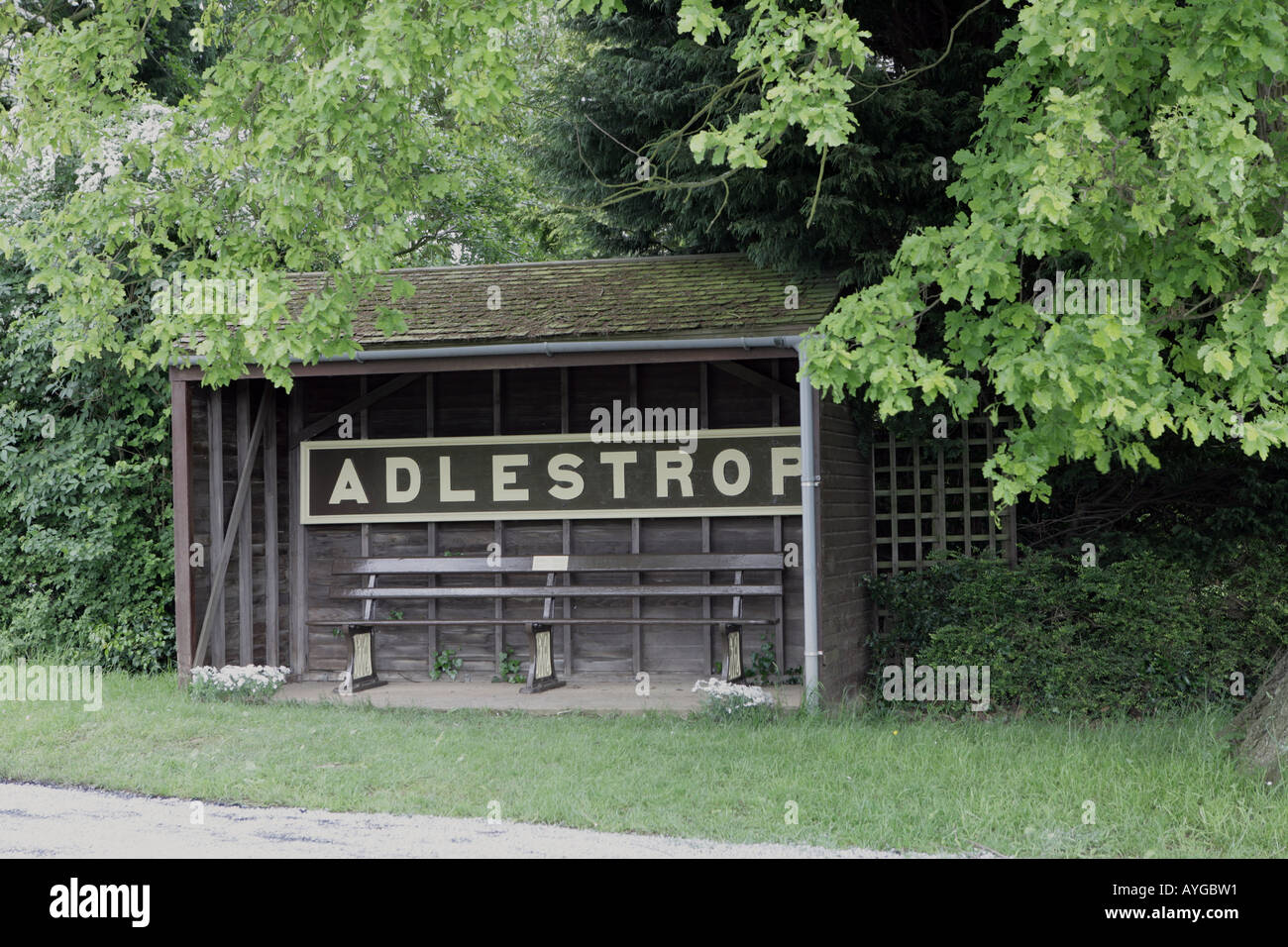 Bus shelter with the station sign and seat in the Cotswold village of ...