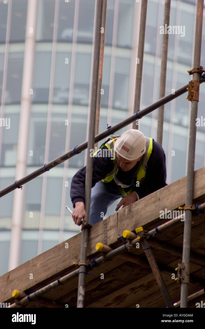 scaffolding scaffolder builder erecting scaffold at height with City ...